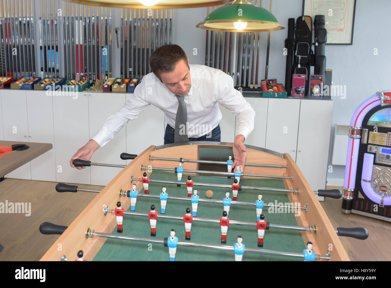 man having fun playing table football Stock Photo - Alamy