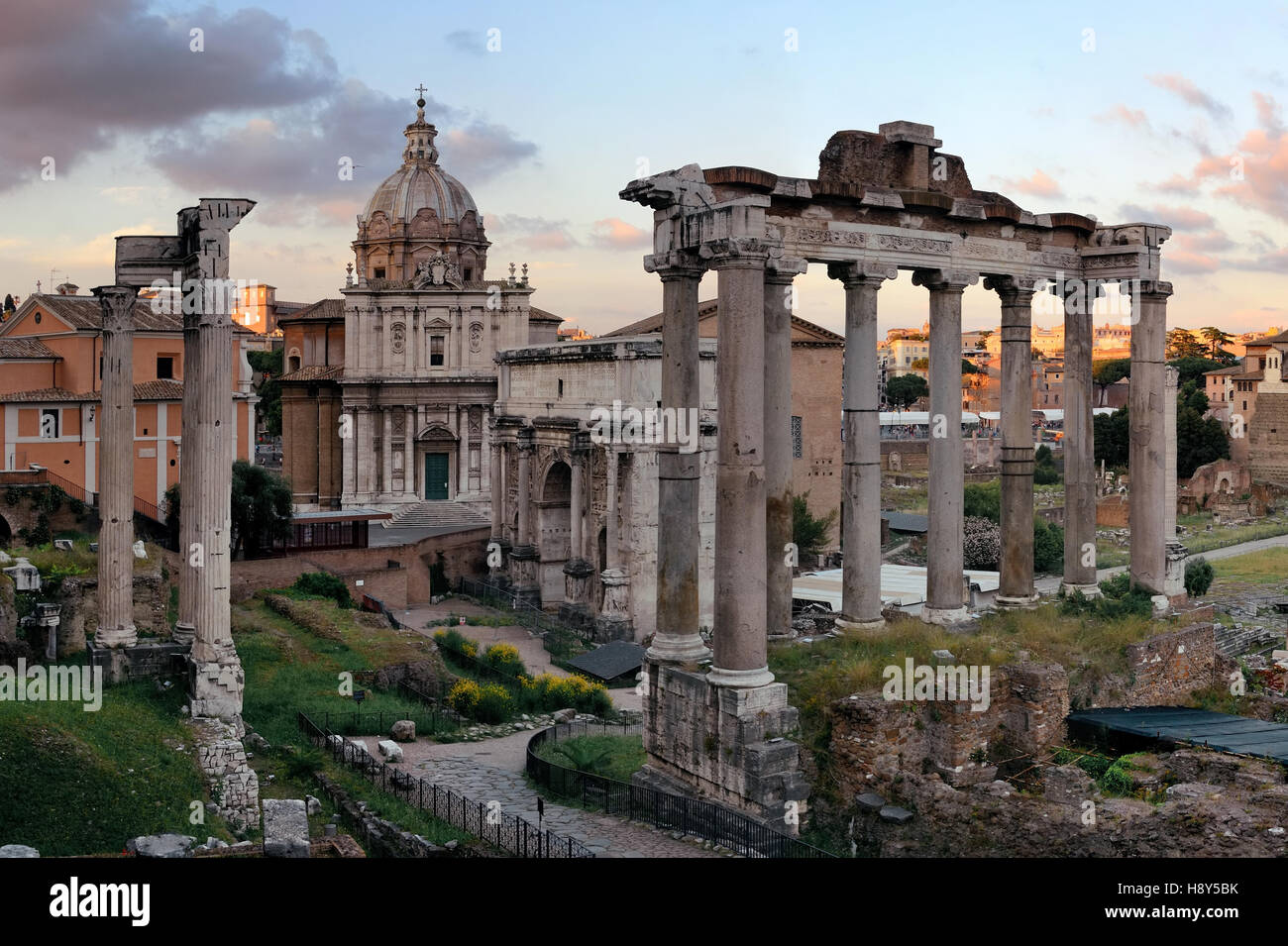 Rome Forum with ruins of ancient architecture at sunset with colorful ...