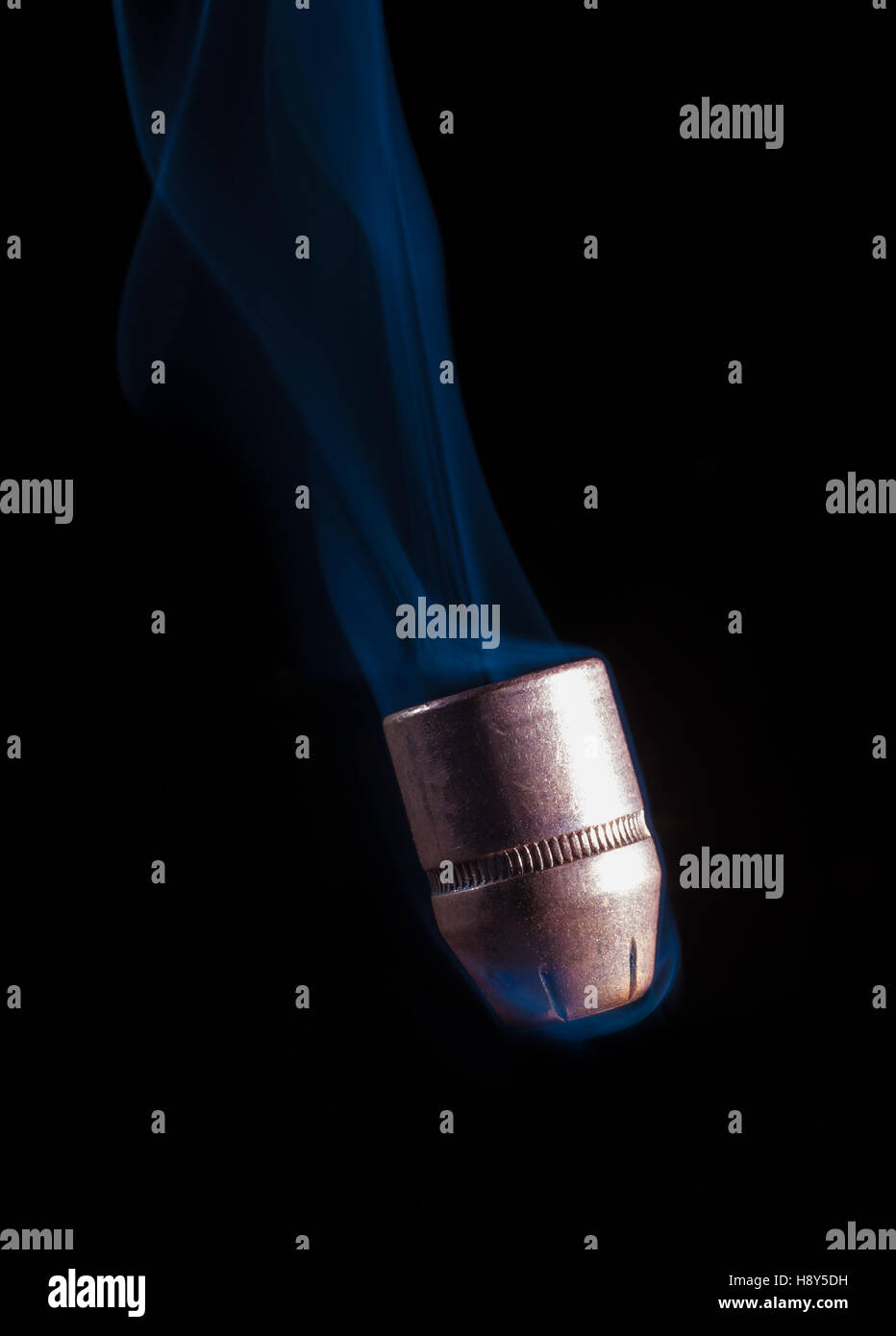 Bullet from a handgun falling toward the ground with smoke Stock Photo ...