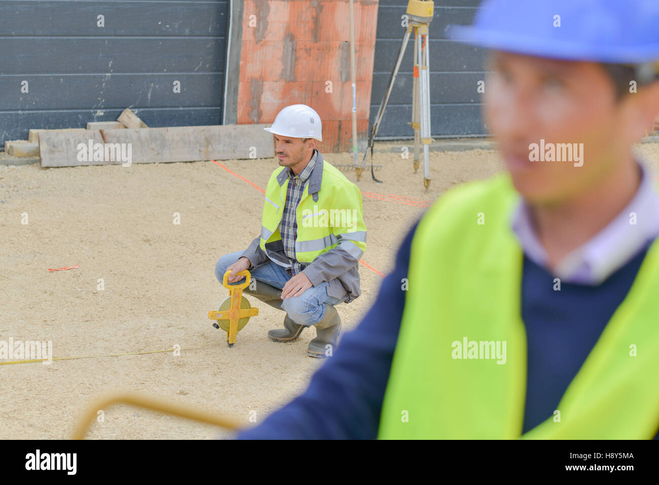builders using measuring tools outdoors in a construction site Stock ...