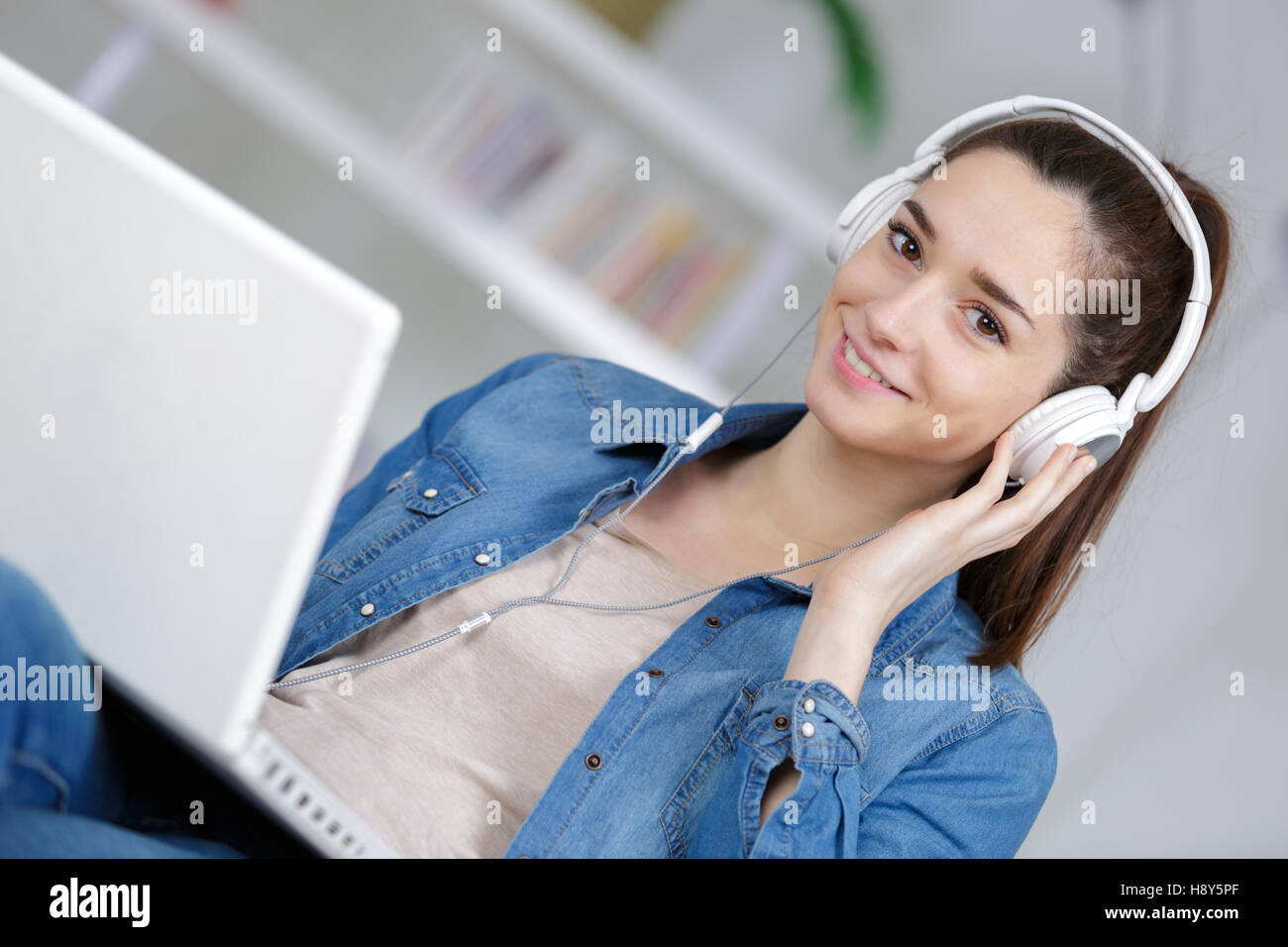 woman listening to music on her laptop Stock Photo - Alamy