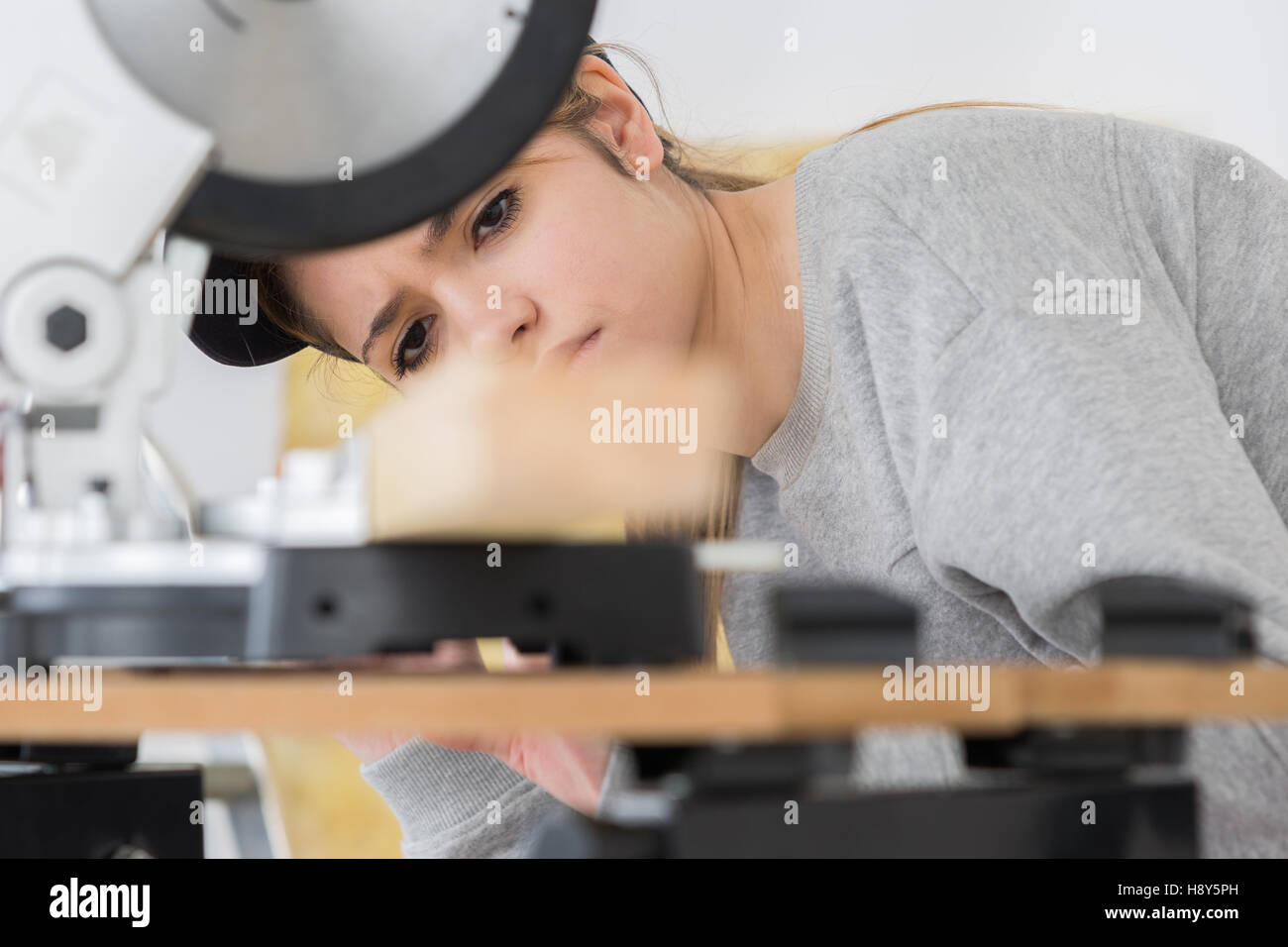 checking the drop saw Stock Photo - Alamy