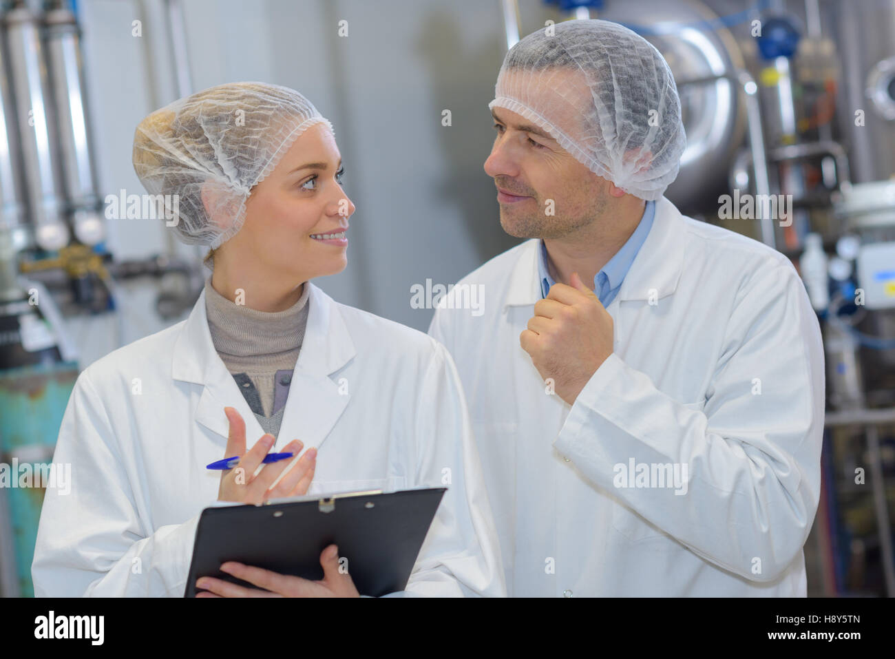 workers in uniform testing the dairy production process Stock Photo - Alamy