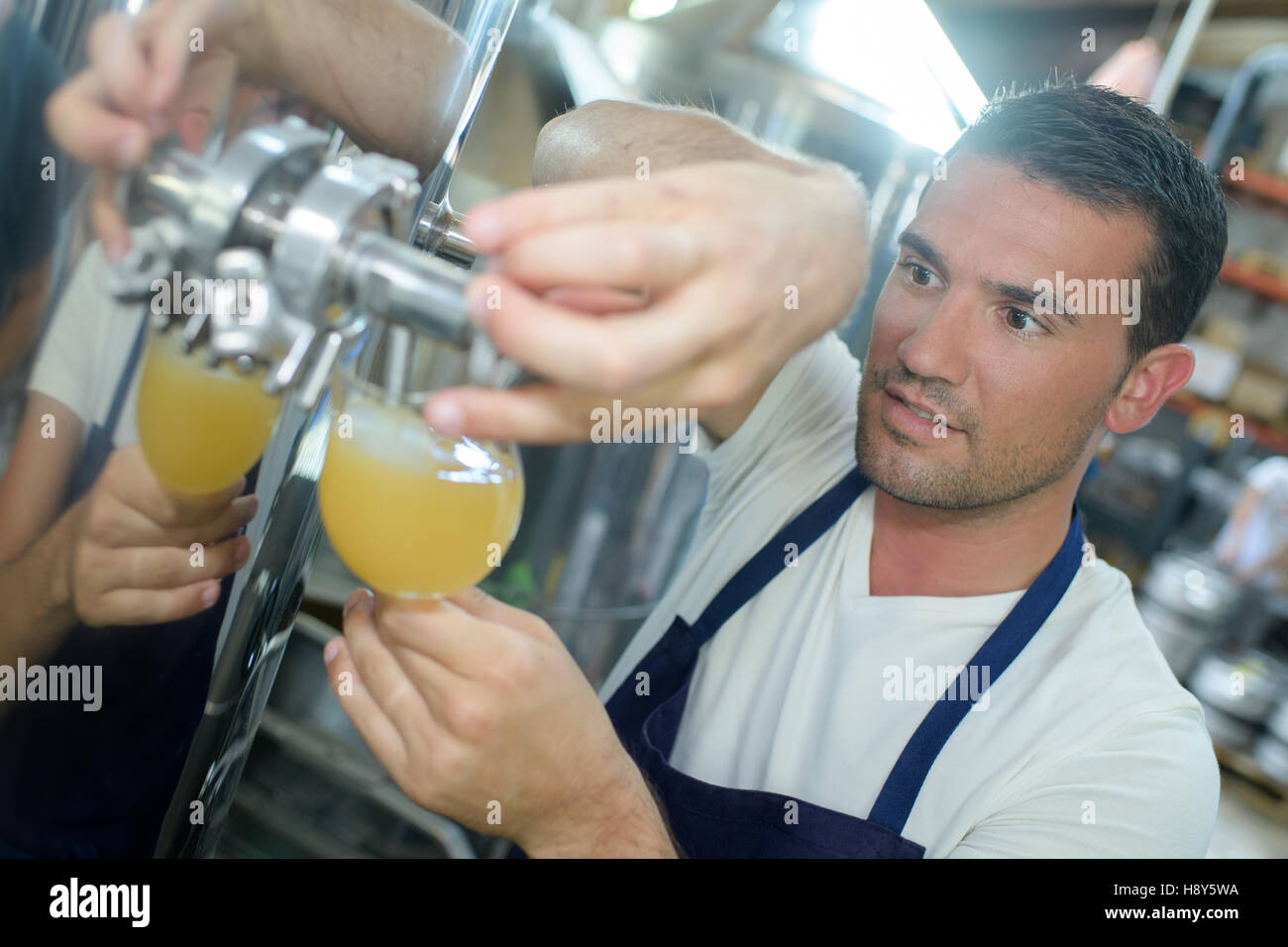 young man pouring beer Stock Photo - Alamy