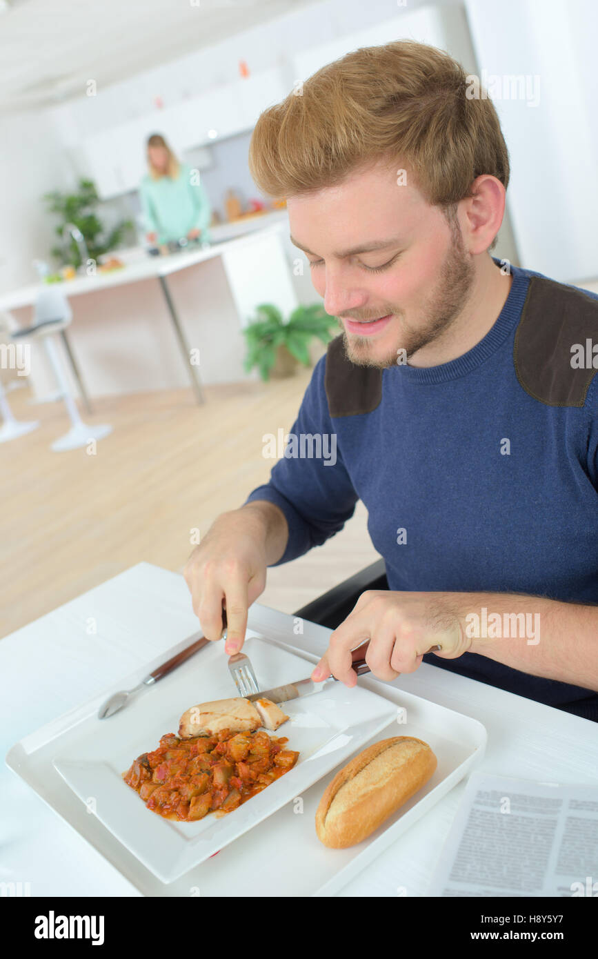 nice looking young man eating at home Stock Photo - Alamy