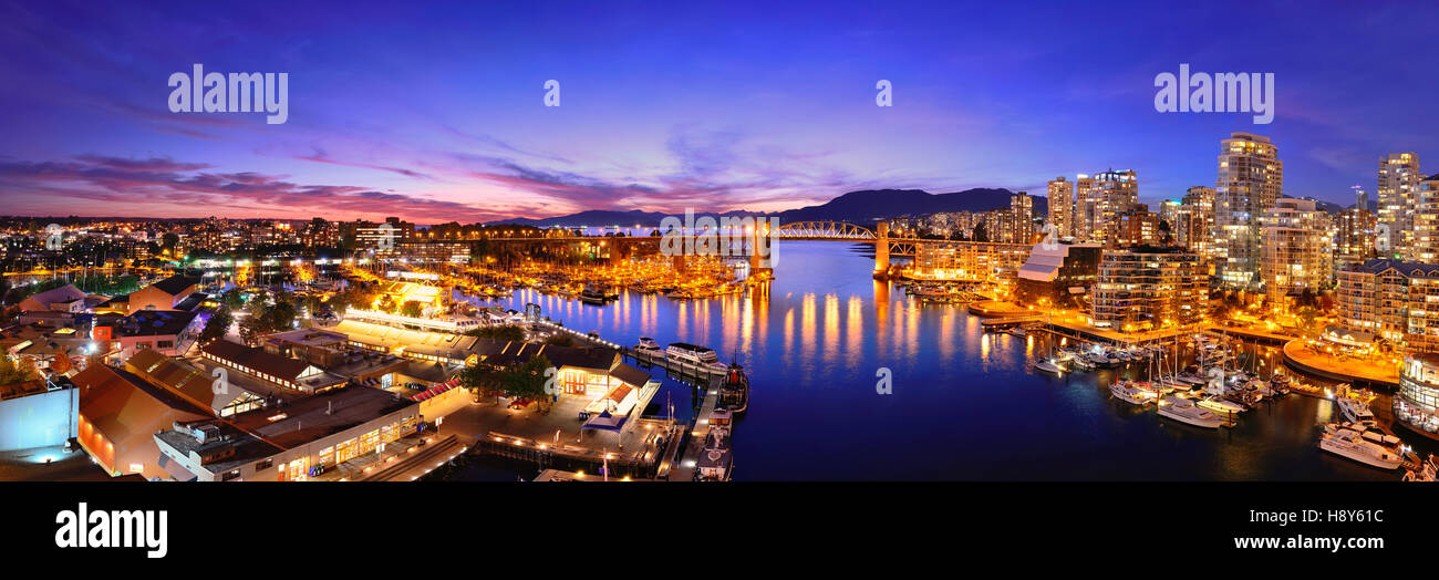 Vancouver harbor view with urban apartment buildings and bay boat at ...