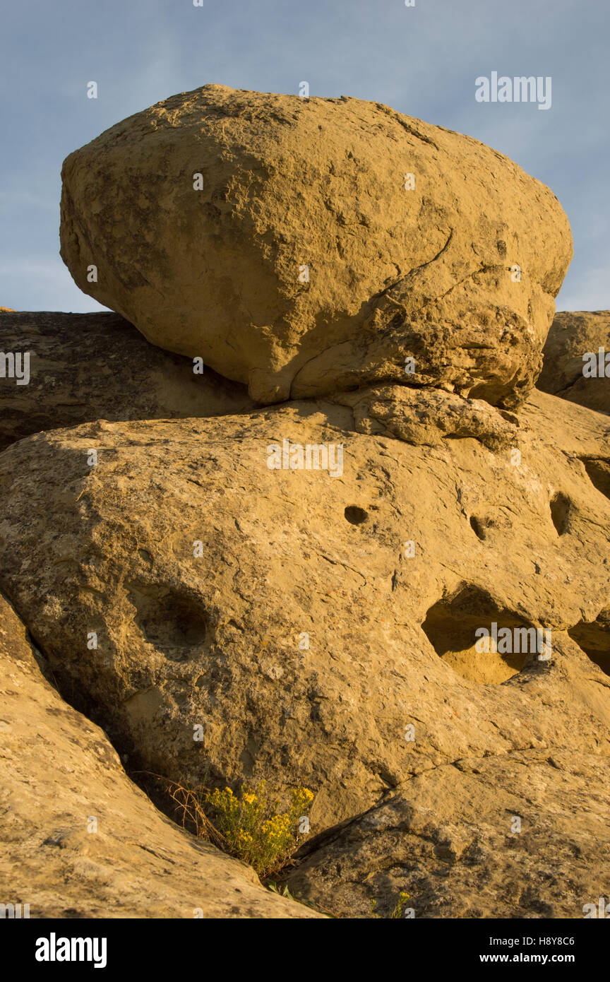 Spherical sandstone rock on top of larger sandstone formation showing ...