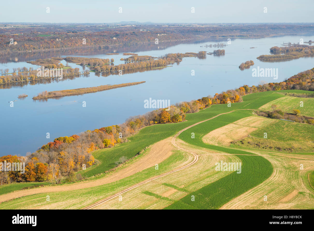 Aerial view of harvested farm fields and woods in northeast Iowa along ...