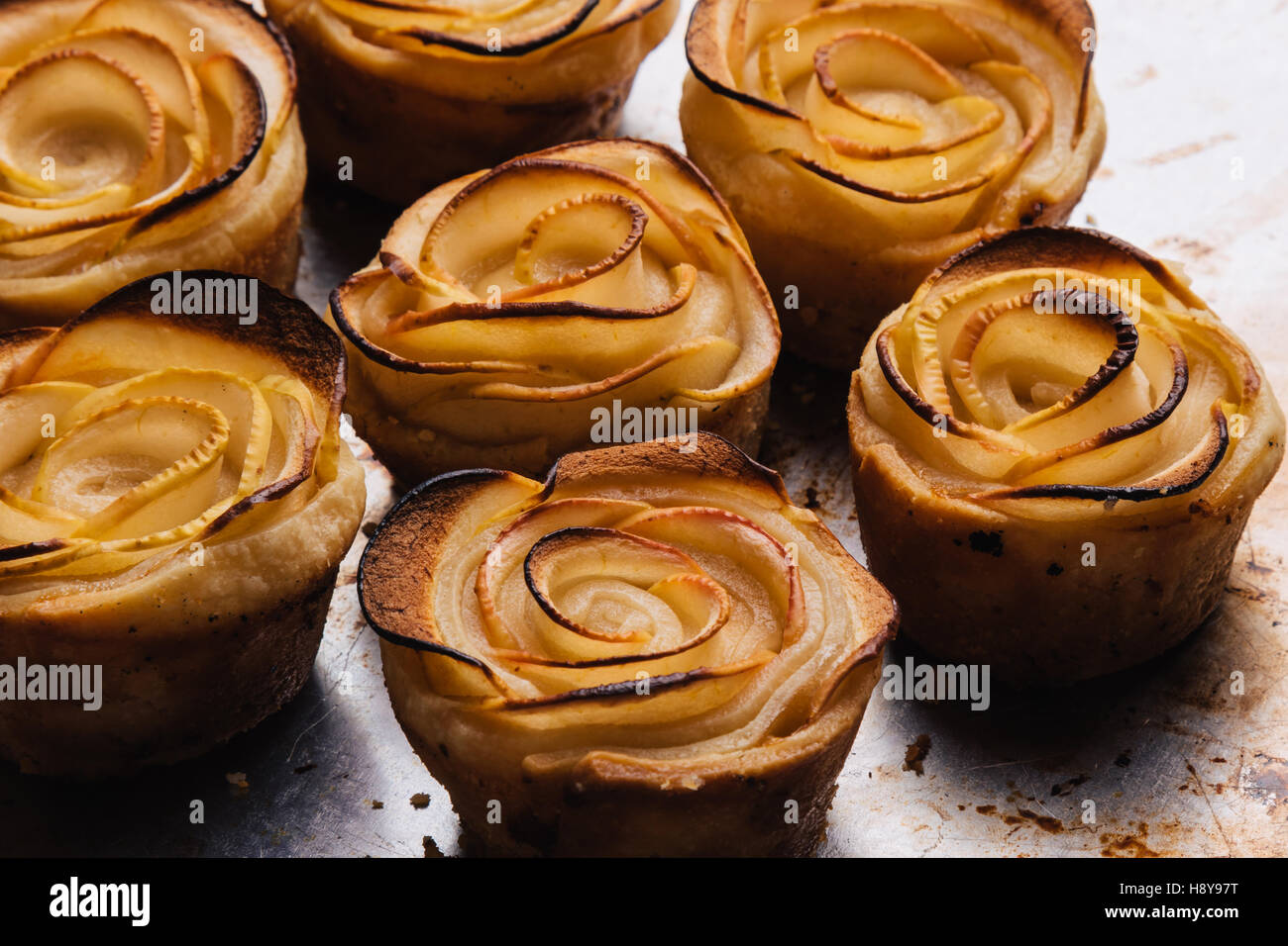 homemade puff pastry with apple shaped roses on steel plate Stock Photo ...