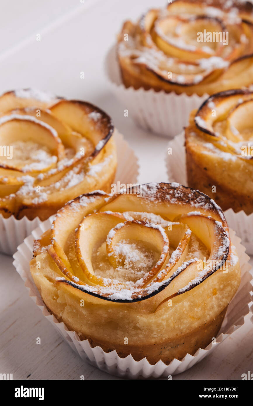 homemade puff pastry with apple shaped roses on white table Stock Photo ...