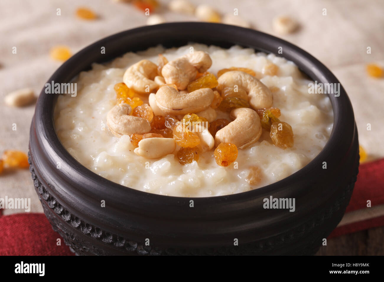sweet rice pudding with nuts and raisins in a bowl close-up on the ...