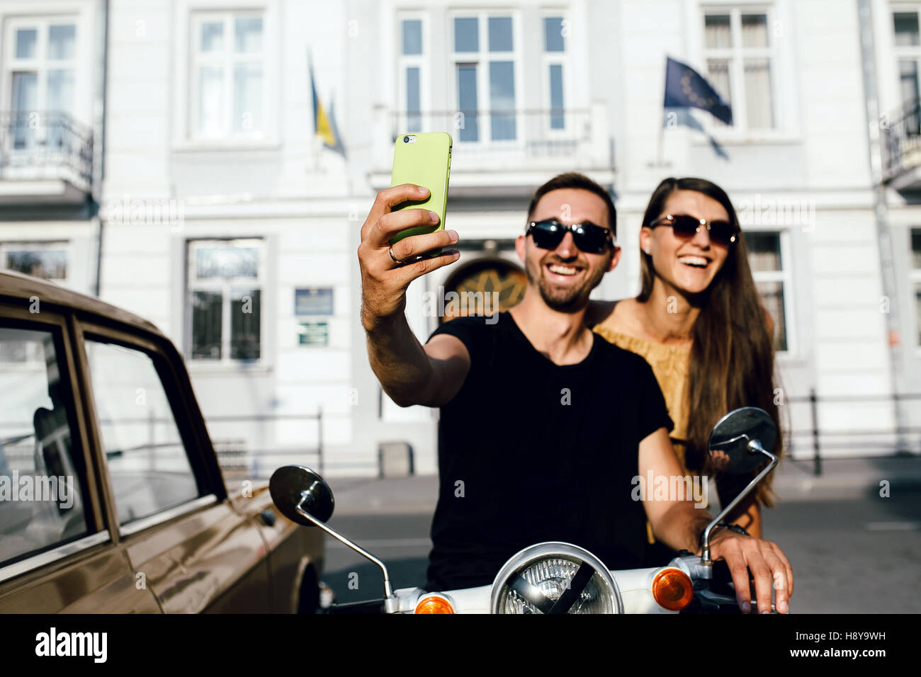 Cute couple make selfie on a scooter Stock Photo - Alamy