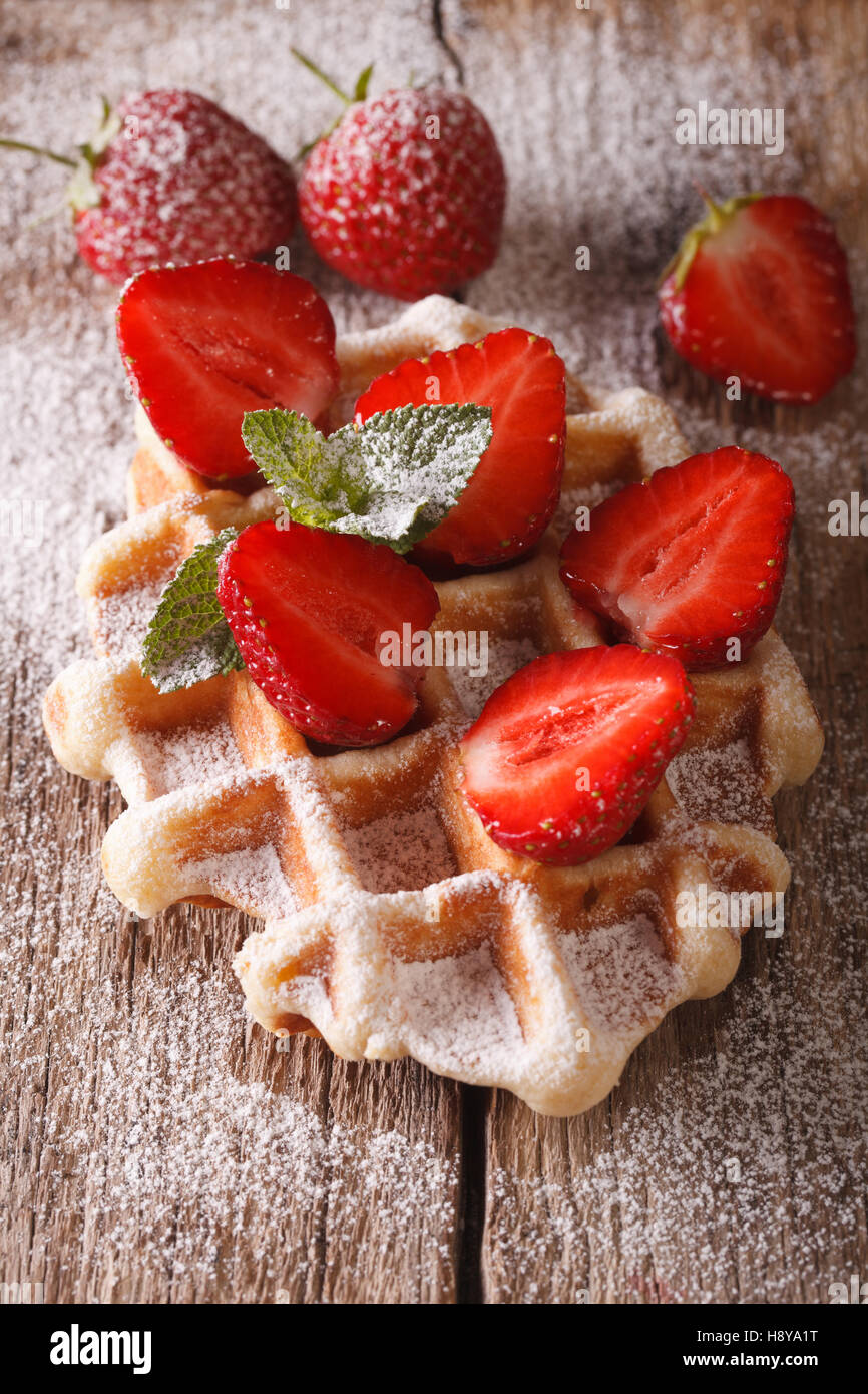 Belgian waffles with strawberries and powdered sugar close-up on the ...