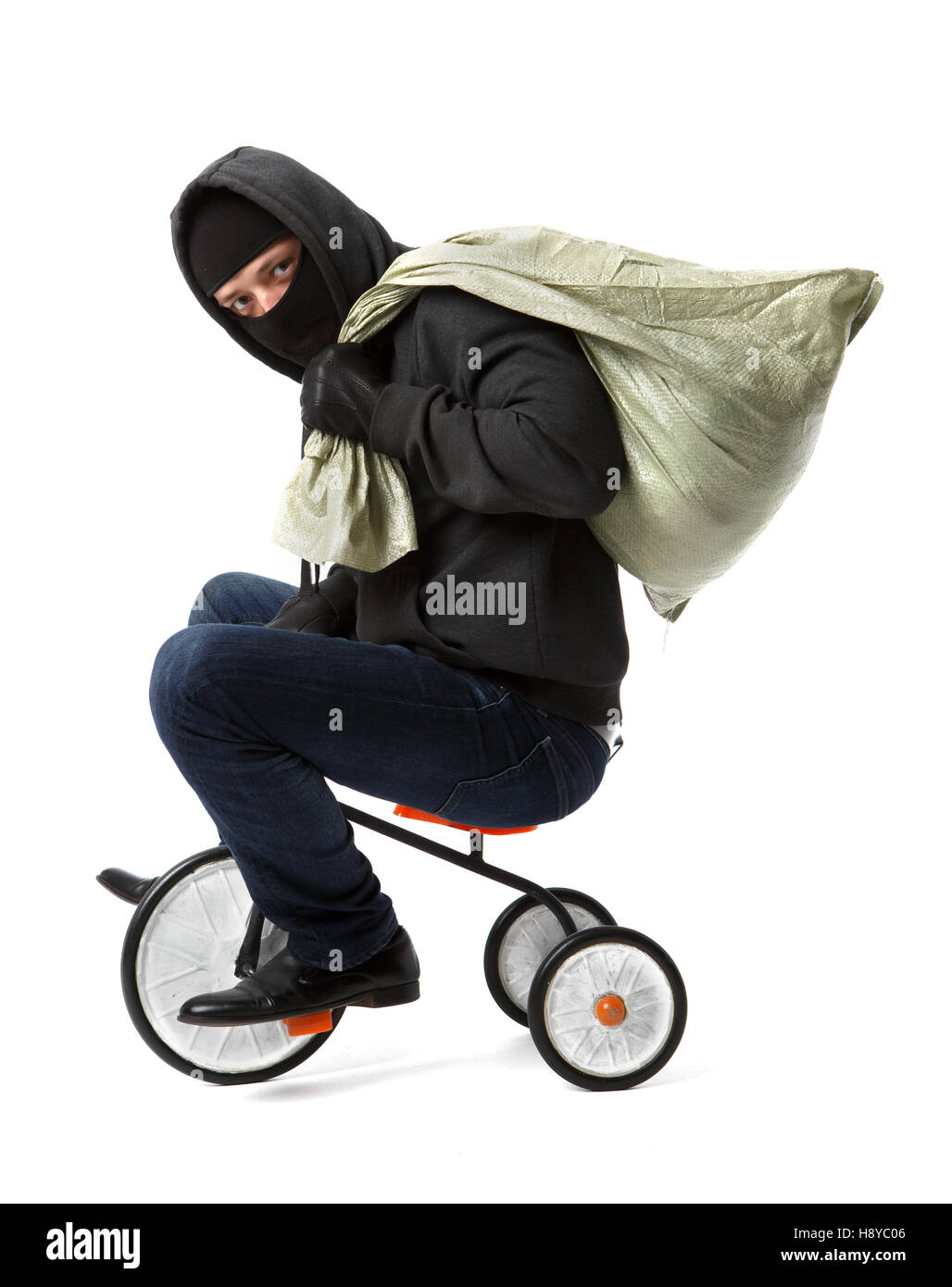 Thief with bag on bicycle Stock Photo - Alamy