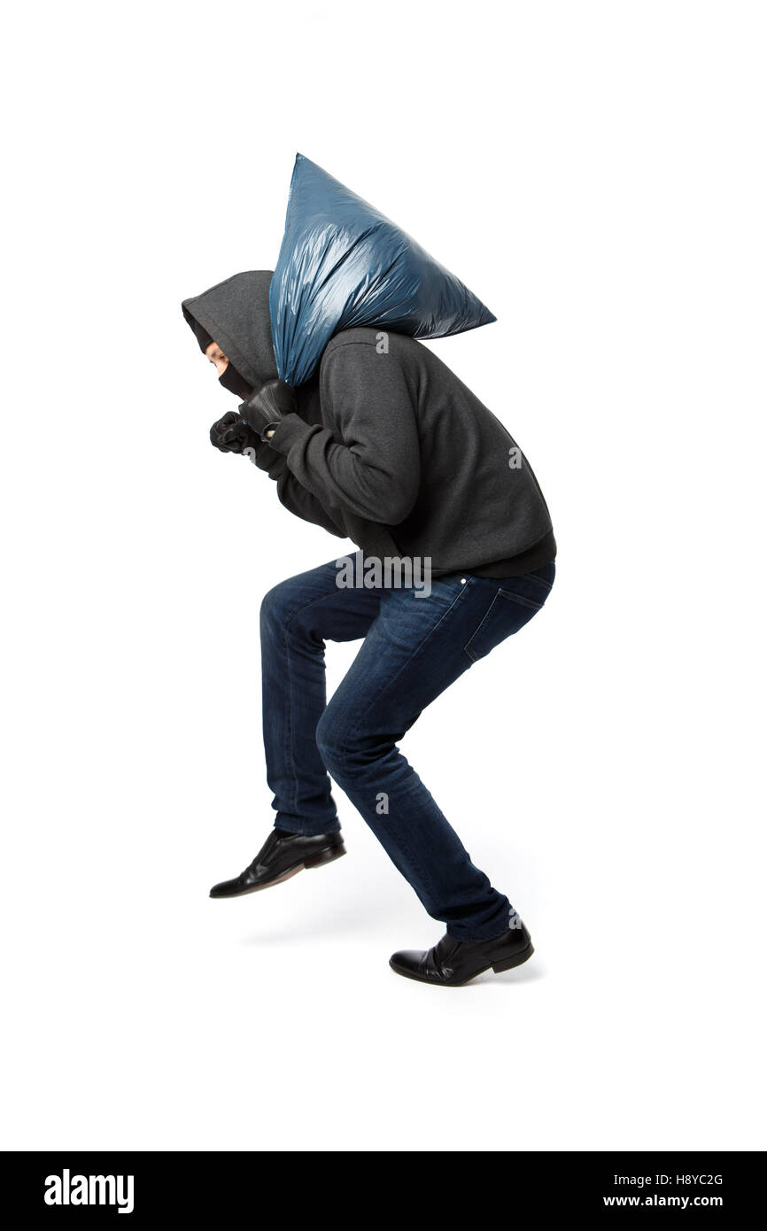 Robber slinking with large bag Stock Photo - Alamy