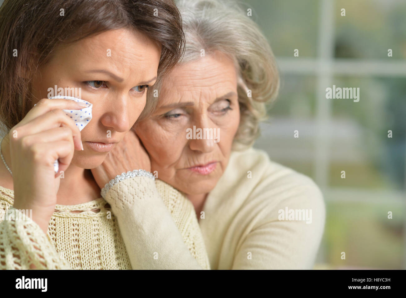 Sad senior and young women Stock Photo - Alamy