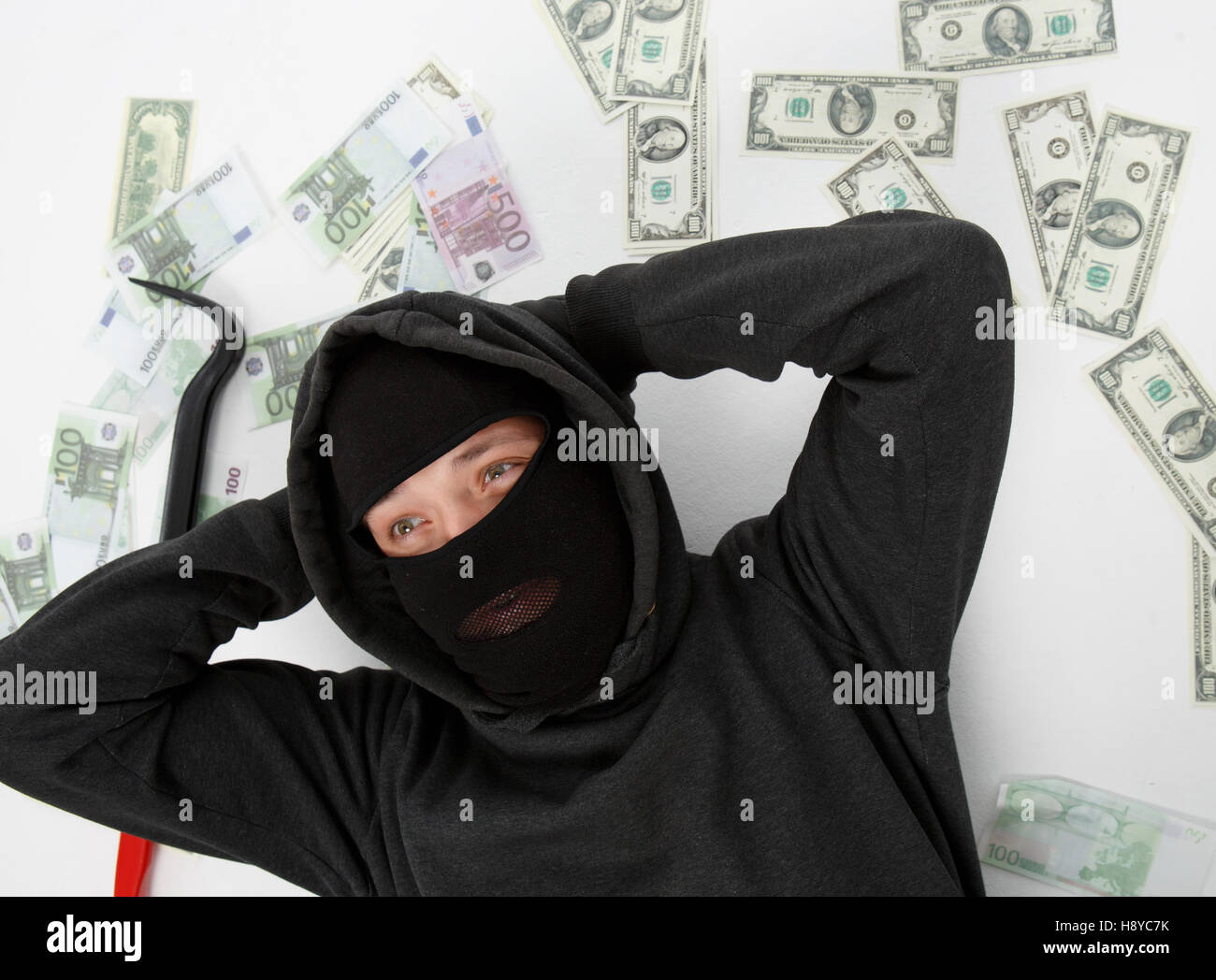 Robber lying on white floor Stock Photo - Alamy