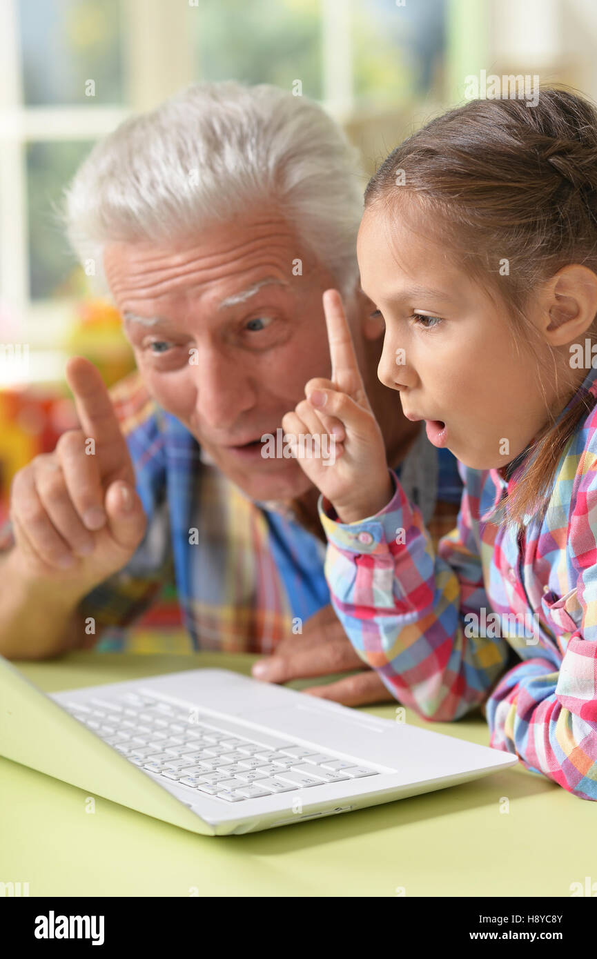 Grandfather and granddaughter with laptop Stock Photo - Alamy
