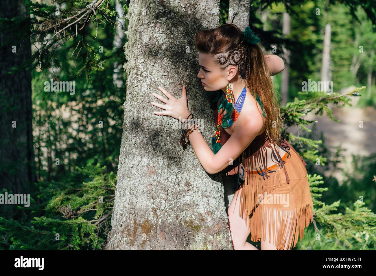 Young and beautiful savage girl in forest Stock Photo - Alamy