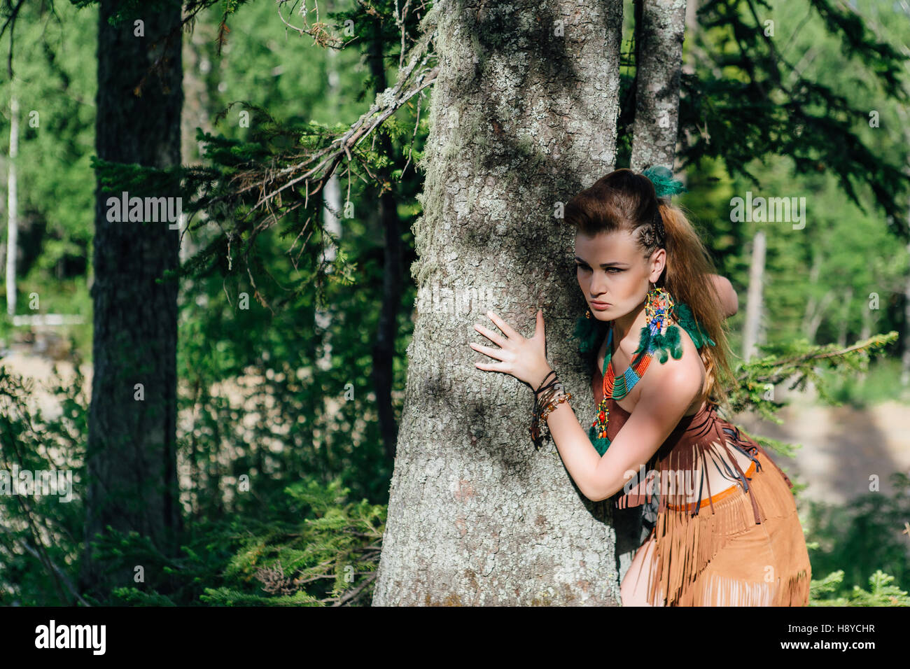 Young and beautiful savage girl in forest Stock Photo - Alamy