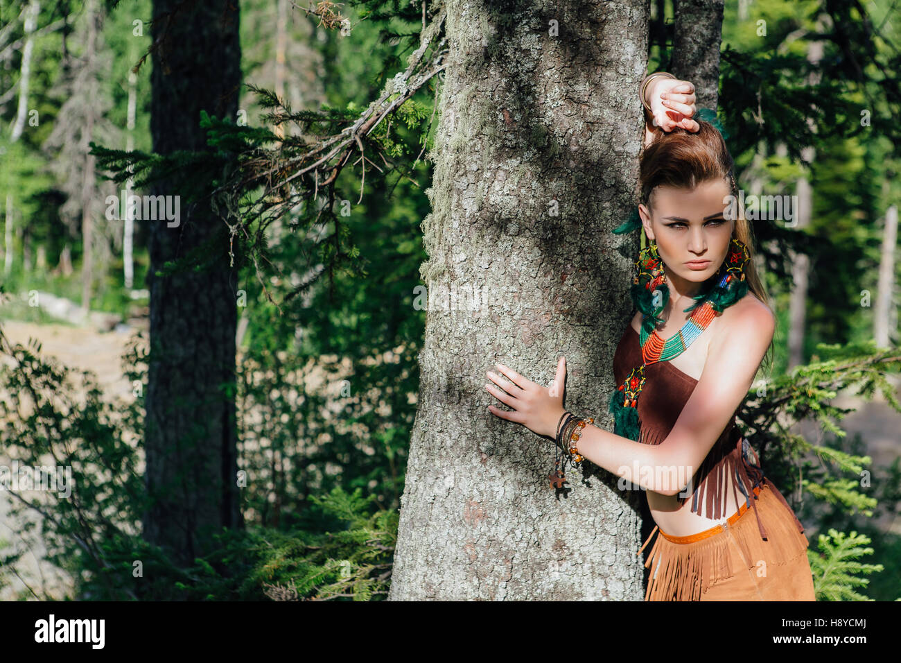 Young and beautiful savage girl in forest Stock Photo - Alamy
