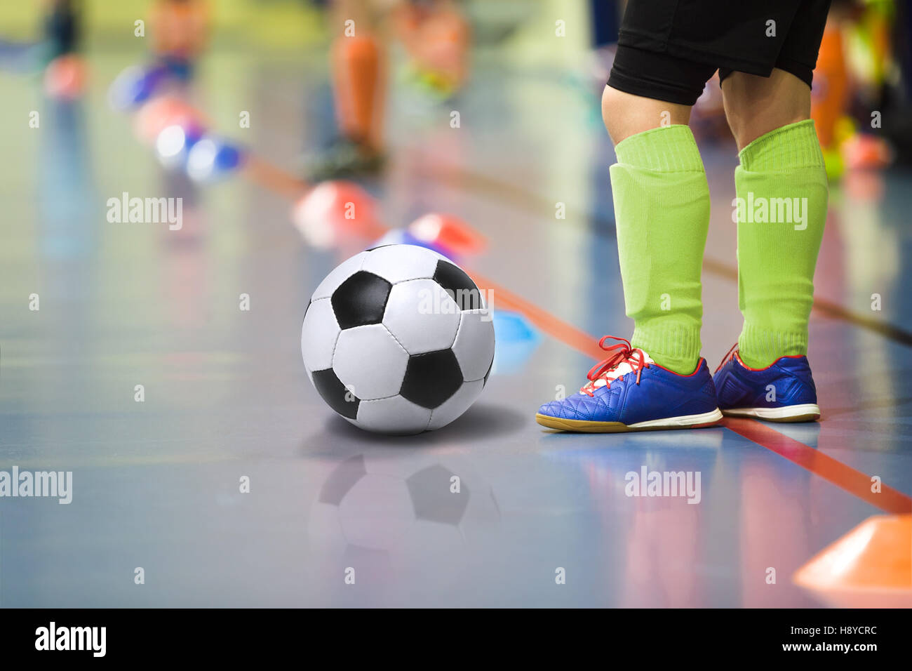 Children training soccer futsal indoor gym. Young boy with soccer ball ...