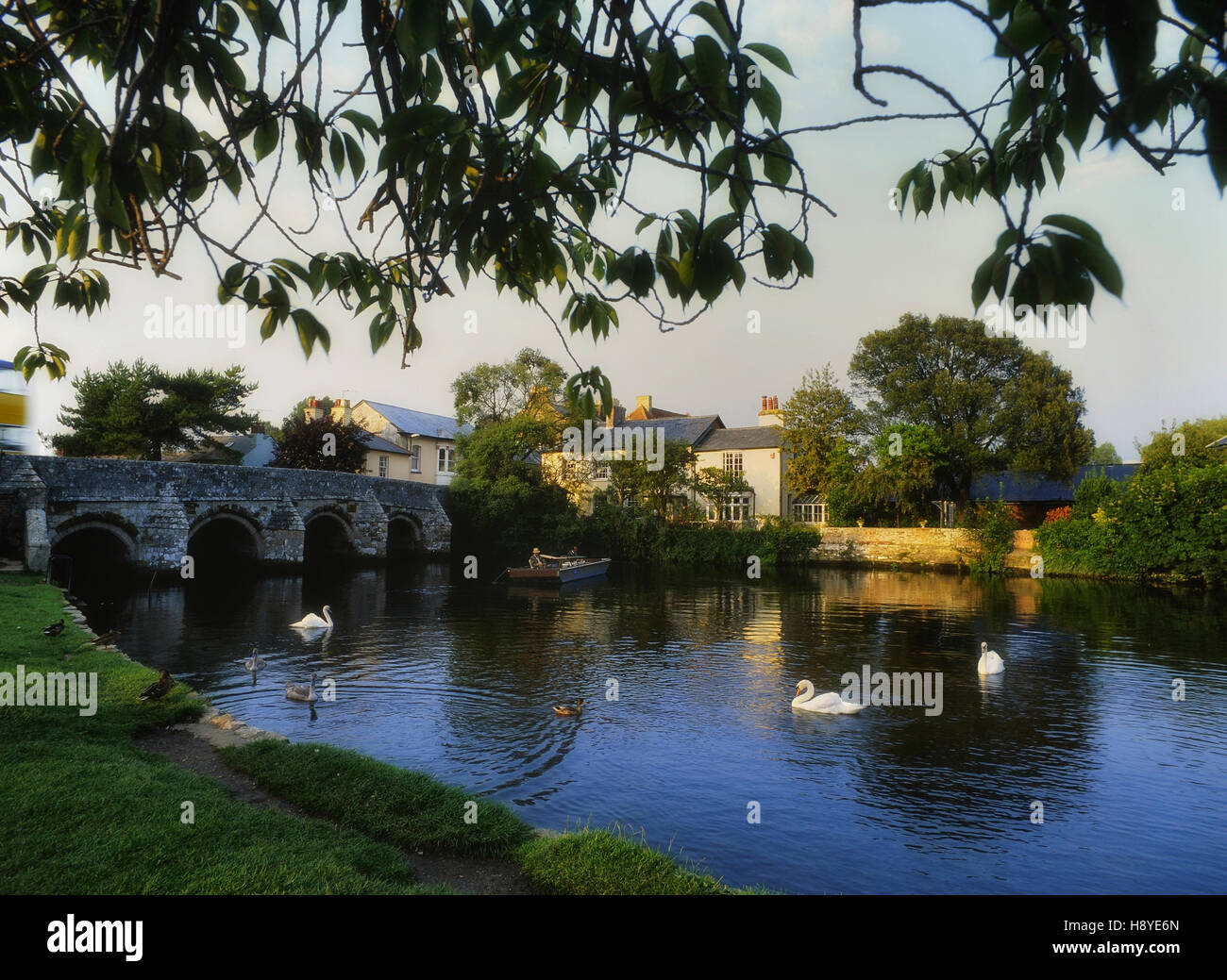 Anglers fishing from the Bridge Pool punt beside Christchurch Castle ...