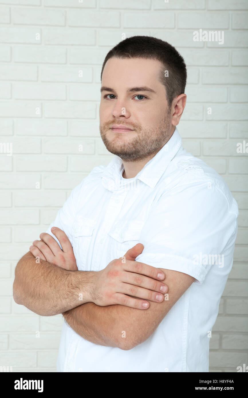 Portrait of a men in studio gray background Stock Photo - Alamy