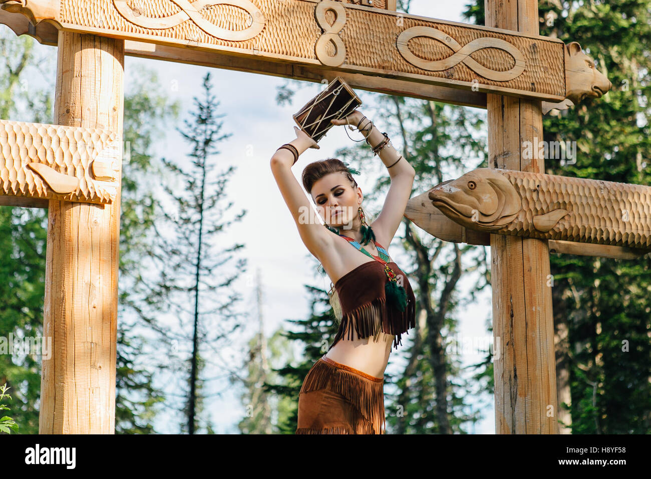Young and beautiful savage girl in forest Stock Photo - Alamy