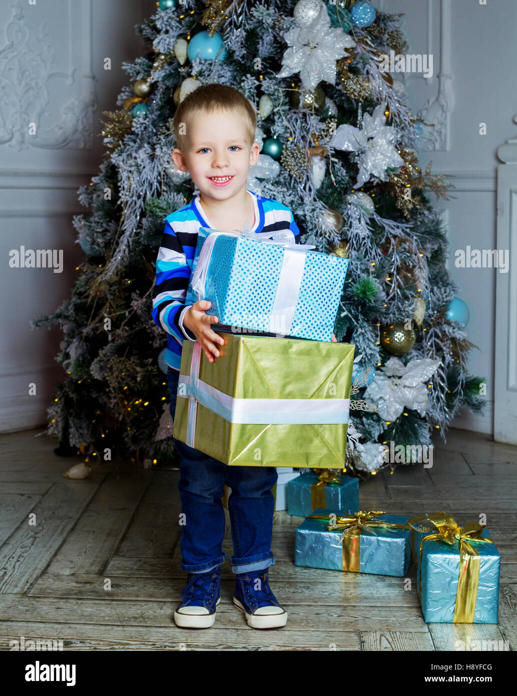 happy child at home with Christmas tree and presents Stock Photo - Alamy