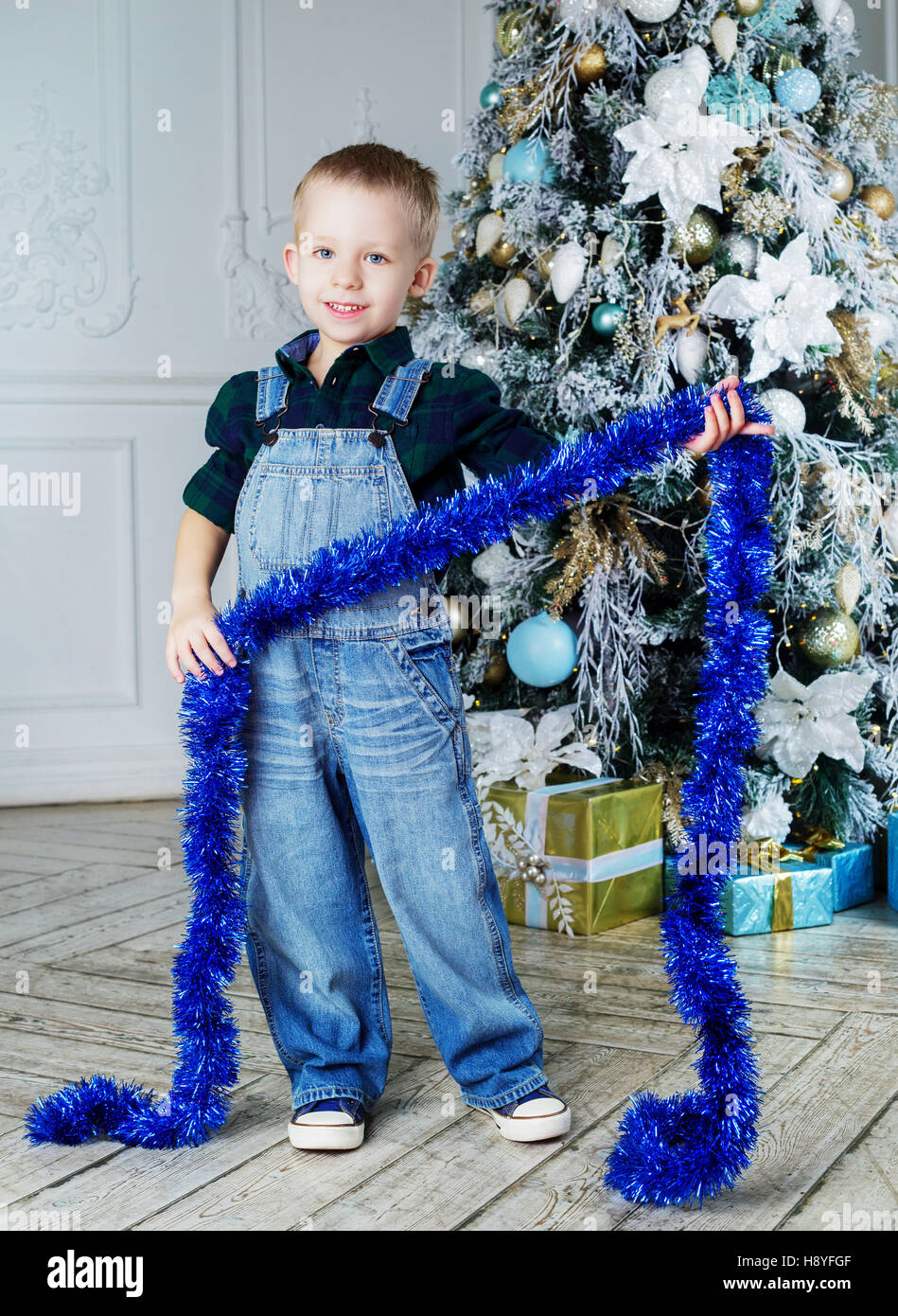 happy child at home with Christmas tree and presents Stock Photo - Alamy