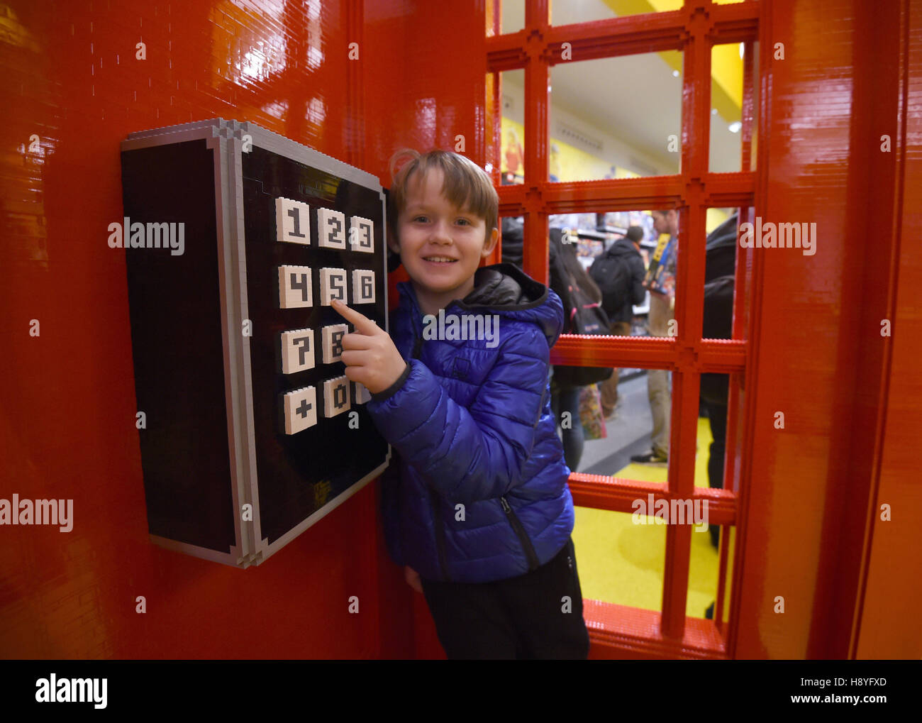Matti (no age given) plays inside a giant telephone box model made of ...