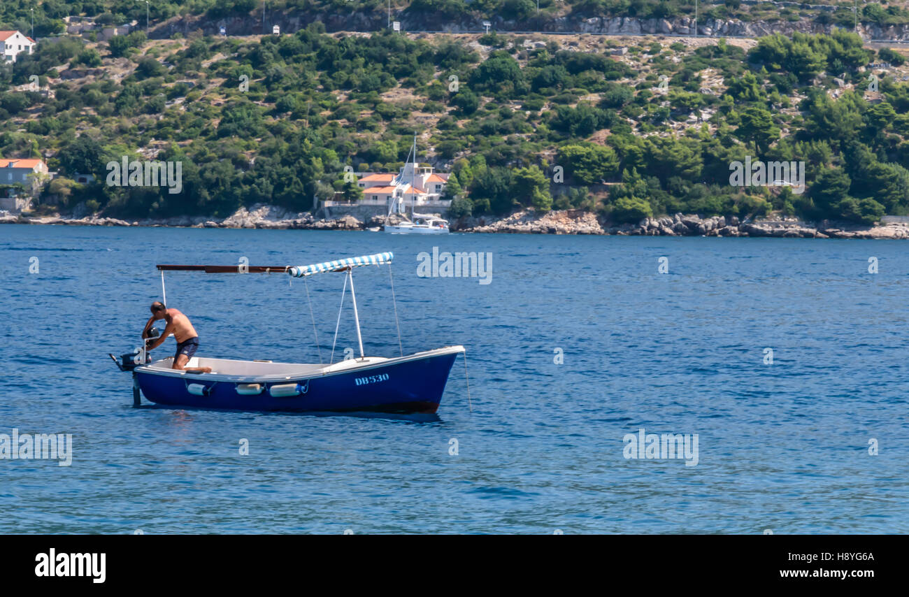 Man repairing his boat Stock Photo - Alamy