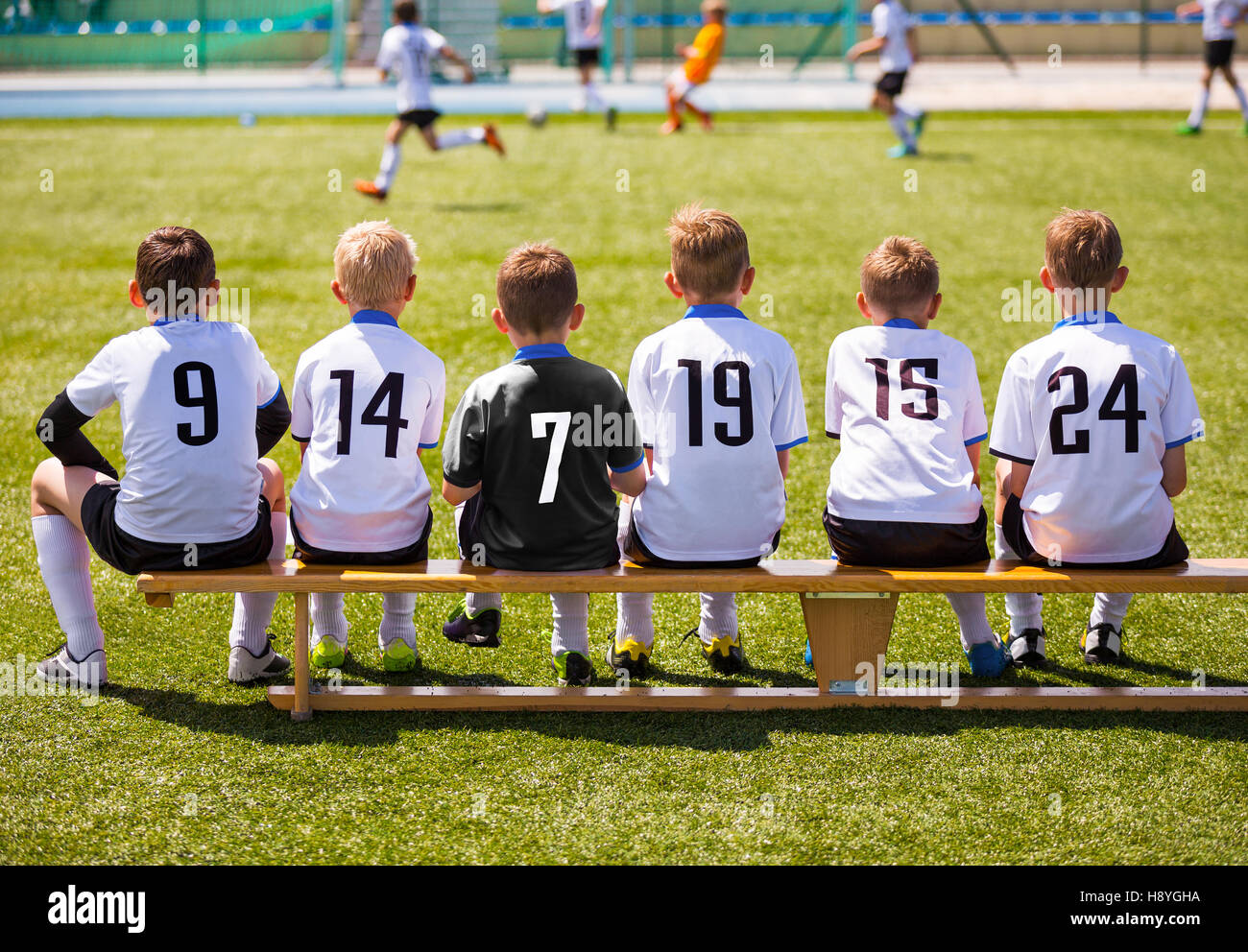 Football Players on Match Game. Young Soccer Team Sitting on Wooden ...
