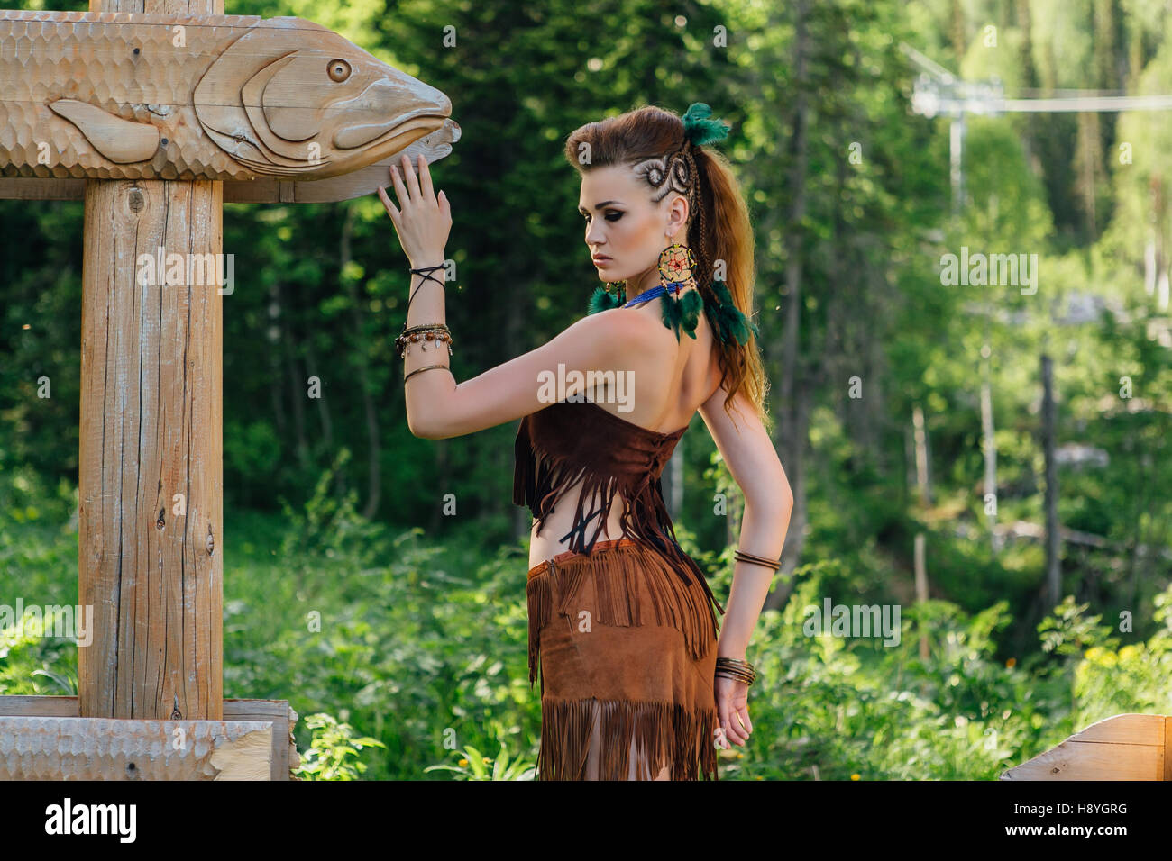 Young and beautiful savage girl in forest Stock Photo - Alamy