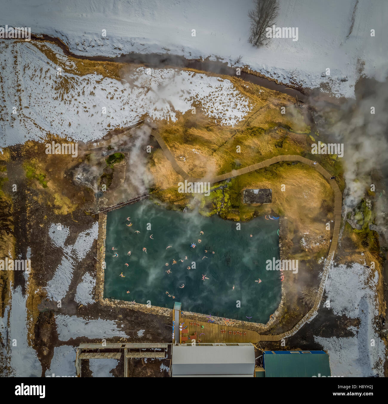 Aerial-People swimming in a natural hot spring- The Secret Lagoon ...