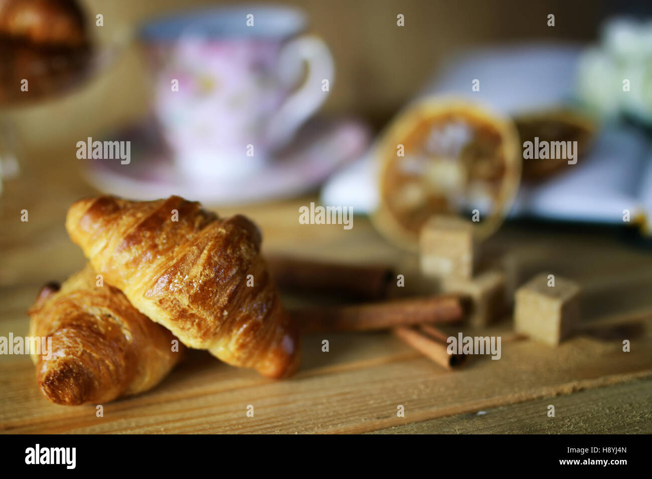 cup with tea croissant book Stock Photo - Alamy