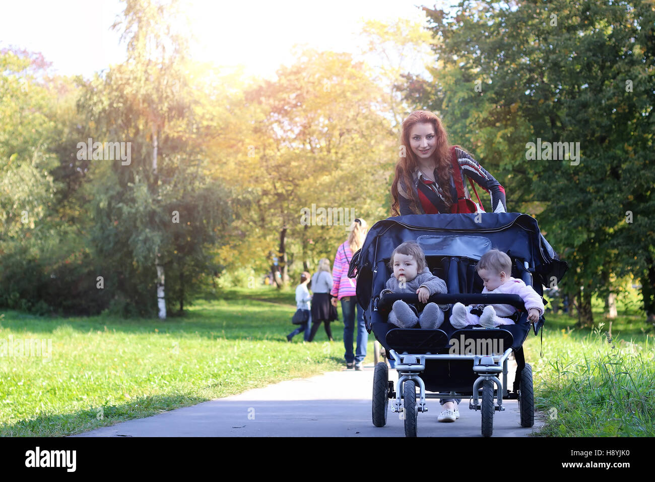 walk women with stroller summer sunlight Stock Photo - Alamy