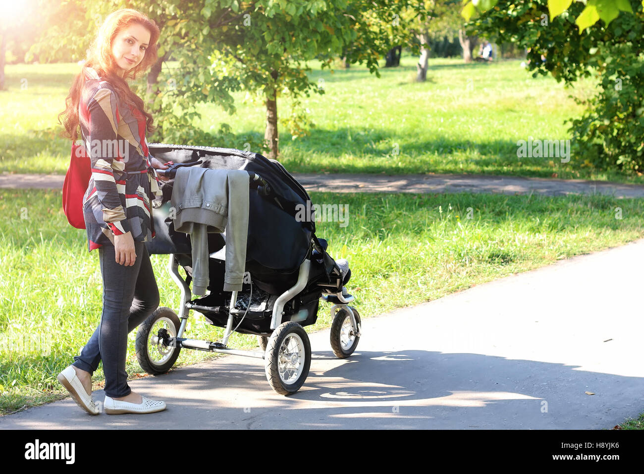walk women with stroller summer sunlight Stock Photo - Alamy
