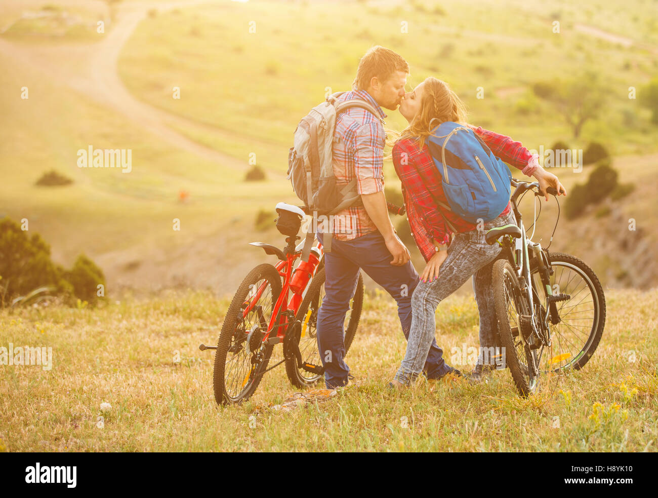 young couple riding bikes in the mountains Stock Photo - Alamy