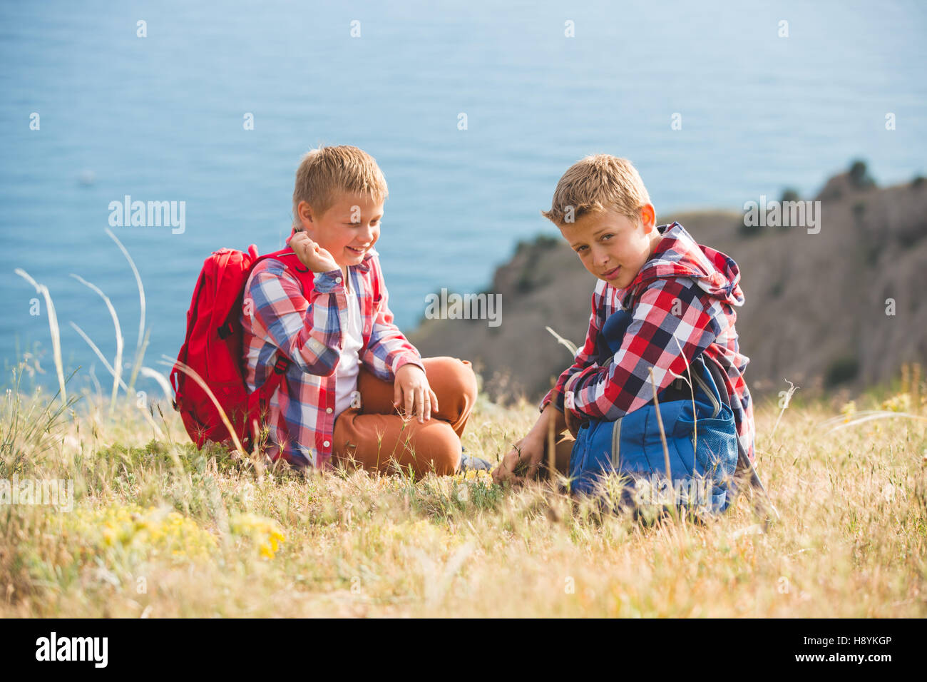 Two brothers walking in mountains near the sea Stock Photo - Alamy