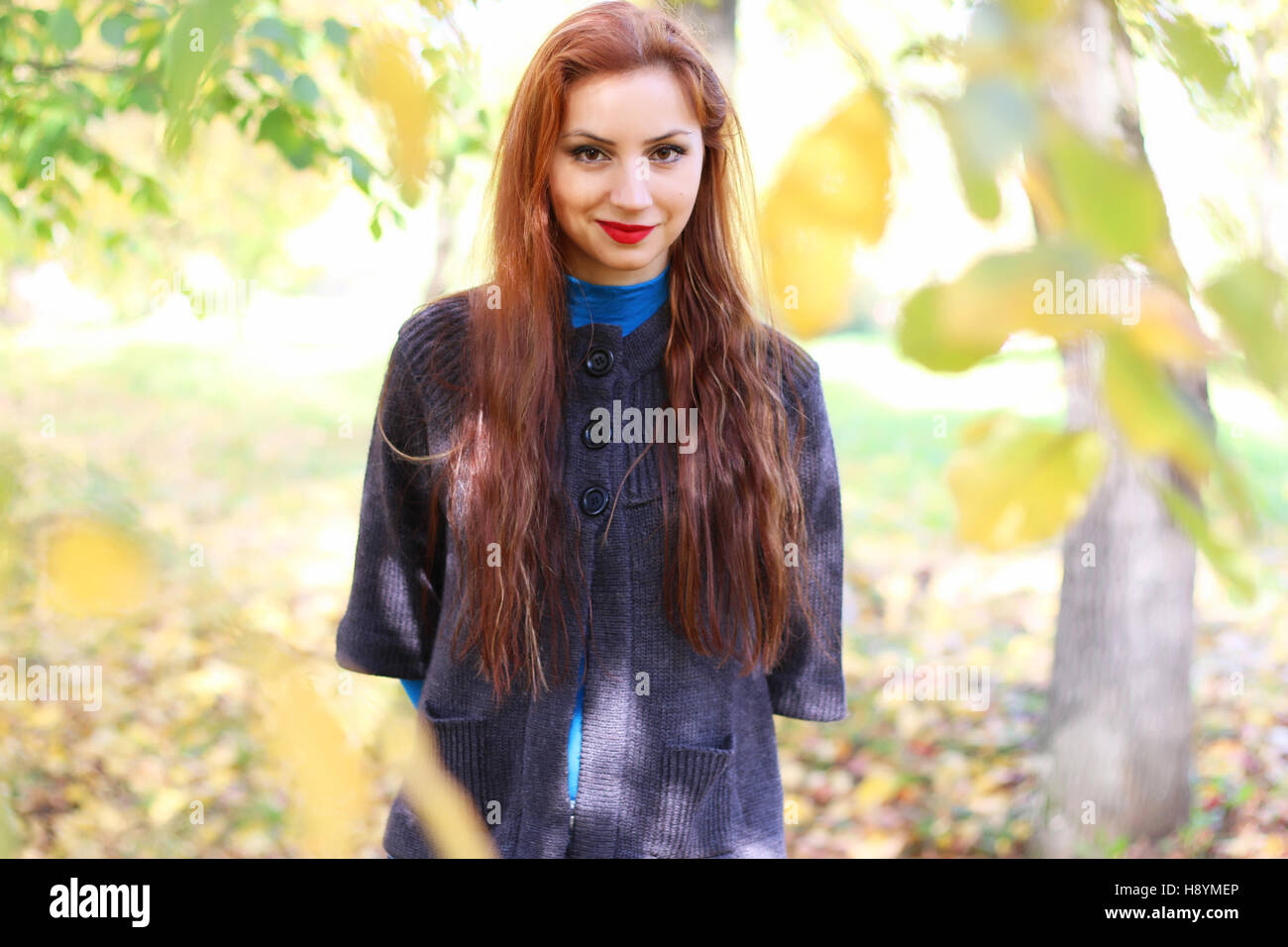 Girl autumn leaves coat Stock Photo - Alamy