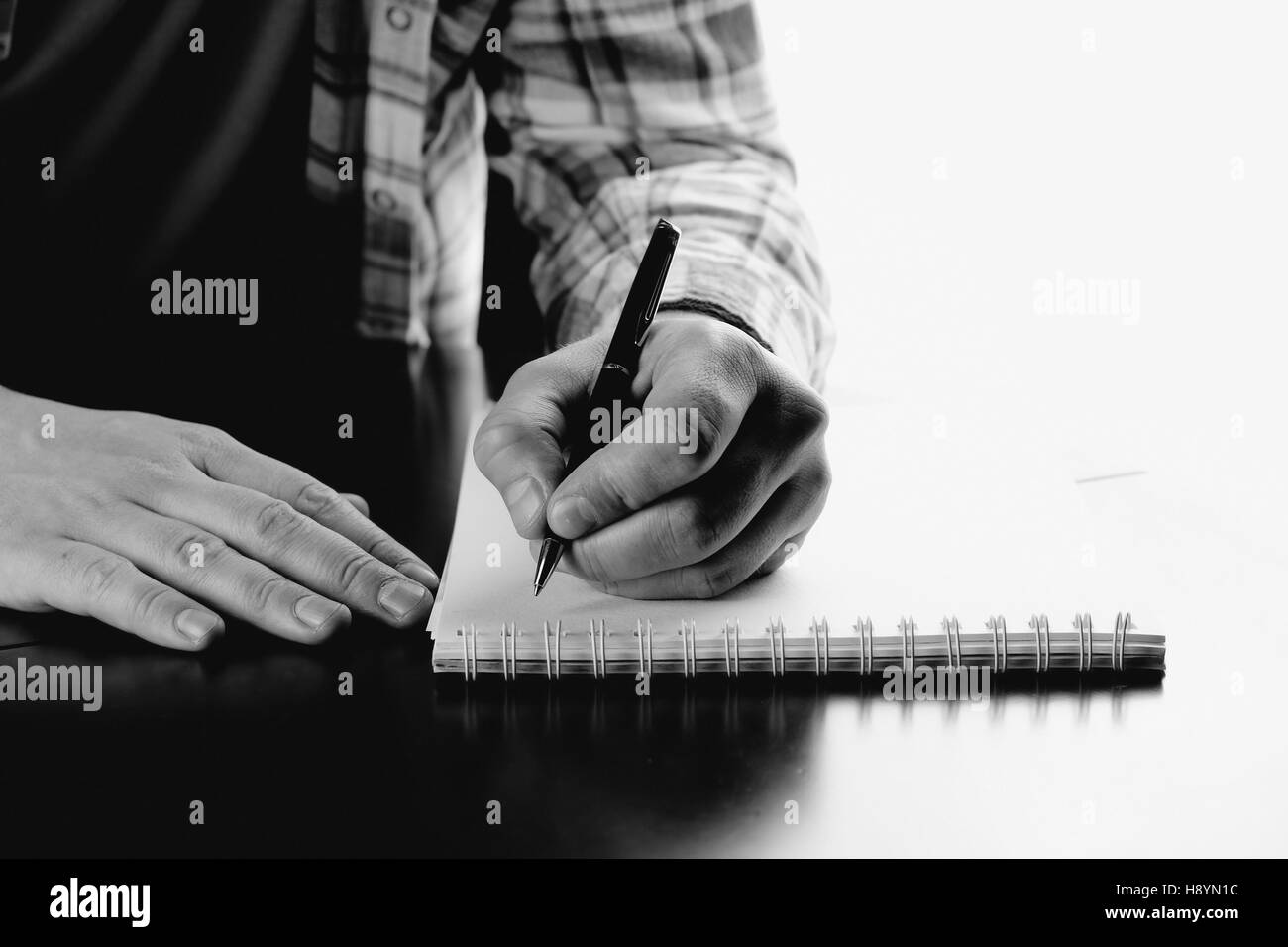 Hand holding notebook pen Black and White Stock Photos & Images - Alamy