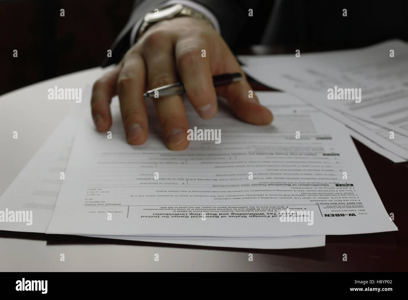 hand signed tax form Stock Photo - Alamy