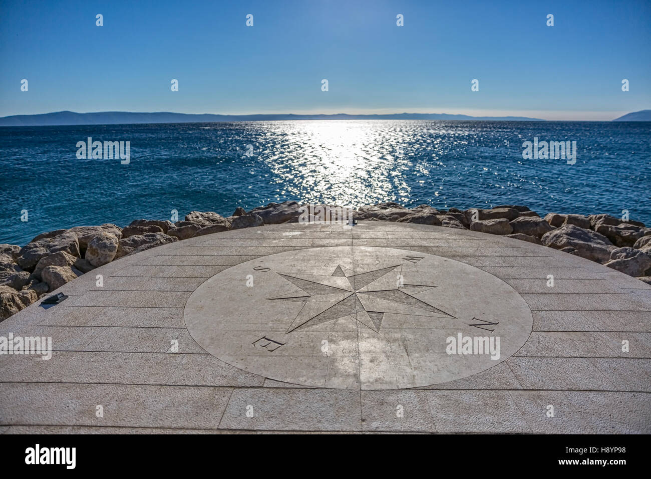 Compass by the sea Stock Photo - Alamy