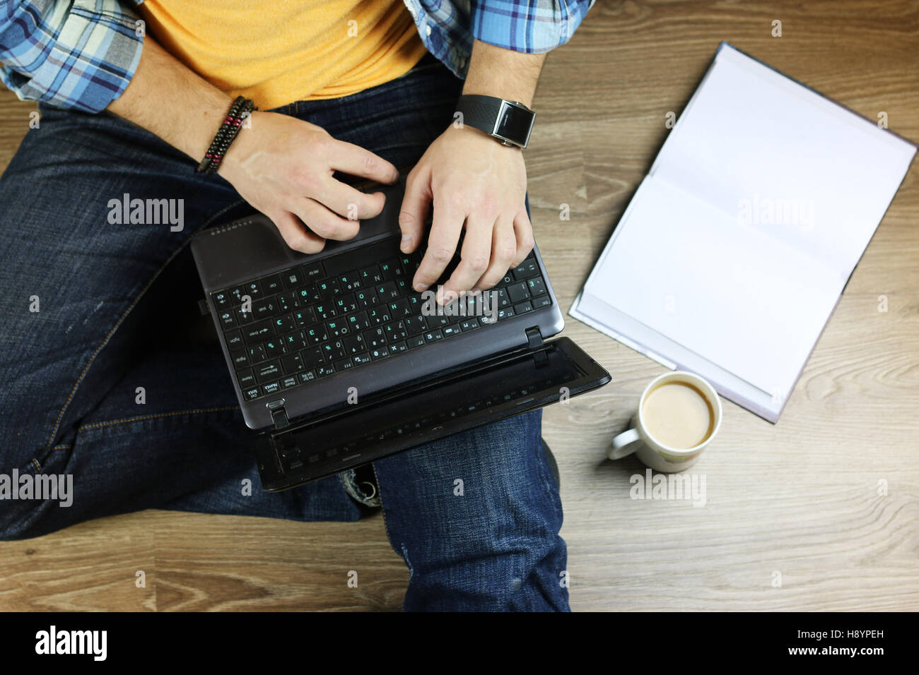 man on the floor with a laptop Stock Photo - Alamy