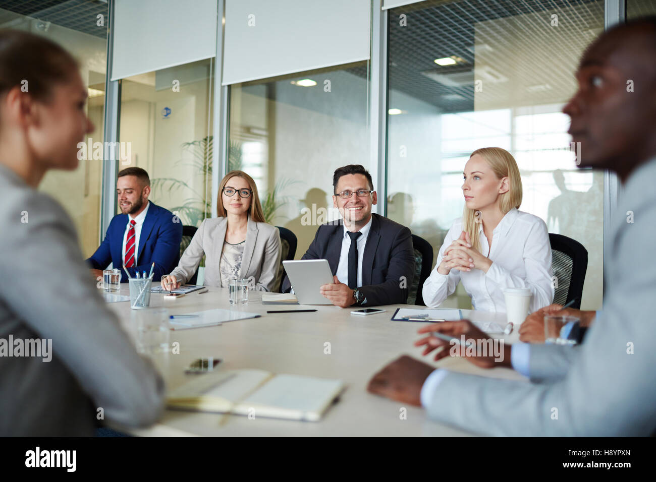 Group of professionals having meeting in boardroom Stock Photo - Alamy