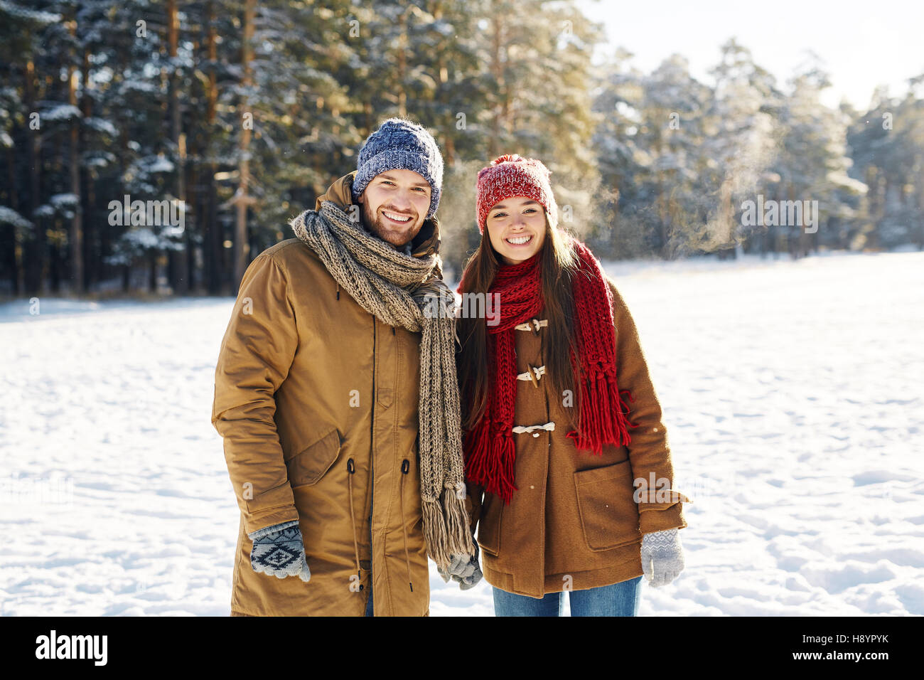 Two young people in winterwear spending time in park Stock Photo - Alamy