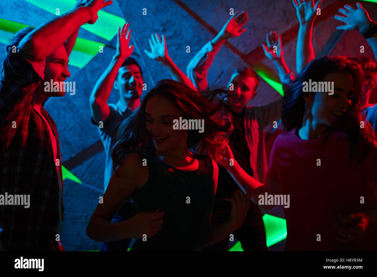 Group of ecstatic teens enjoying dance in night club Stock Photo - Alamy
