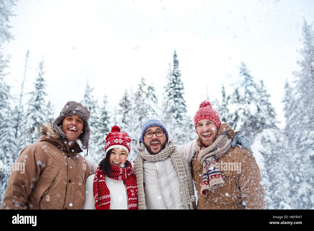 Cheerful friends having walk in blizzard Stock Photo - Alamy